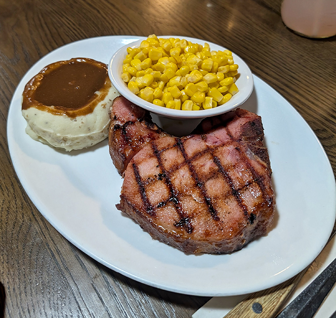 Behold: a perfectly grilled pork chop that could convert vegetarians, sided with corn and gravy-crowned mashed potatoes.