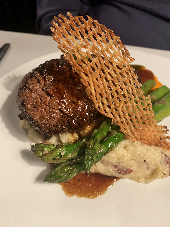 A perfectly seared steak perched atop creamy potatoes with that architectural tuile&mdash;like the Guggenheim Museum decided to go deliciously edible.