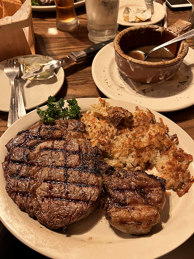 This perfectly seared steak with its beautiful grill marks sits alongside crispy hash browns &ndash; a duo that proves heaven exists and it's on this plate.
