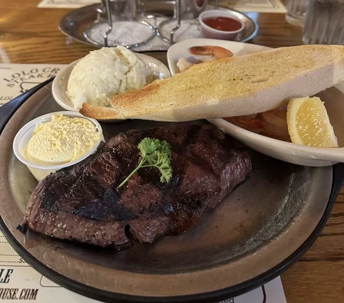 This isn't just a steak; it's a masterpiece of Montana beef artistry with a baked potato sidekick ready for butter immersion.