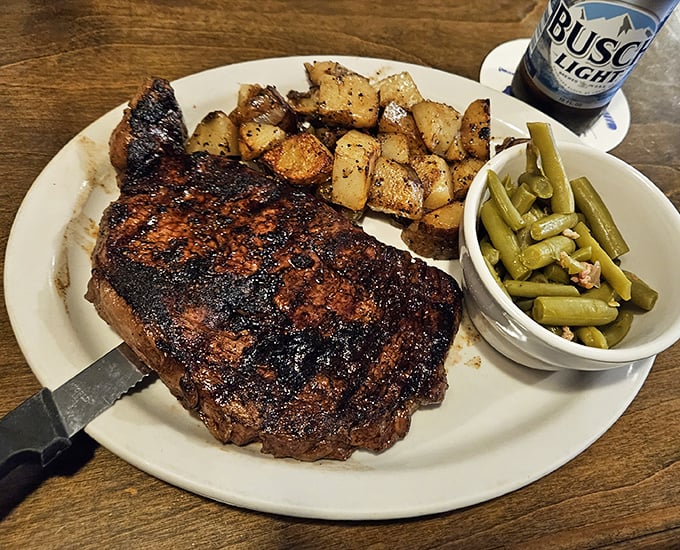 This isn't just a steak; it's a masterpiece with grill marks that belong in the Louvre. The green beans and potatoes are just supporting actors in this meaty drama.