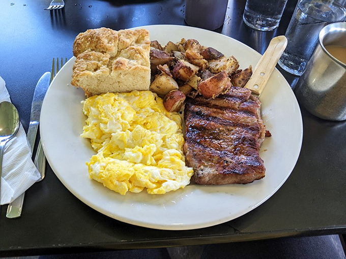 The holy trinity of breakfast perfection: perfectly seasoned steak, fluffy scrambled eggs, and home fries that deserve their own fan club.