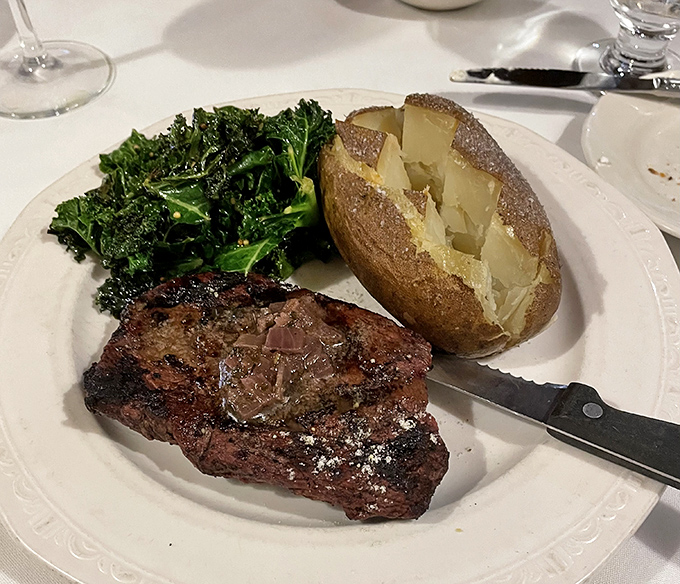 This isn't just dinner; it's a perfectly executed steak with a baked potato and kale that somehow makes you feel virtuous while indulging.