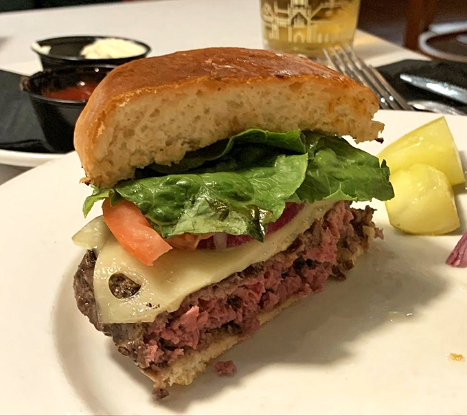 This isn't just a burger; it's architecture &ndash; layers of perfectly cooked beef, melted cheese, and fresh vegetables creating the Taj Mahal of handheld meals.