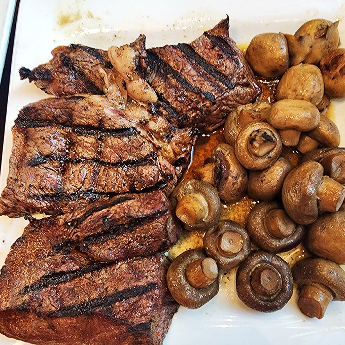 This isn't just a steak; it's a declaration of principles. Perfect grill marks, a generous portion, and mushrooms that have found their soulmate in beef.