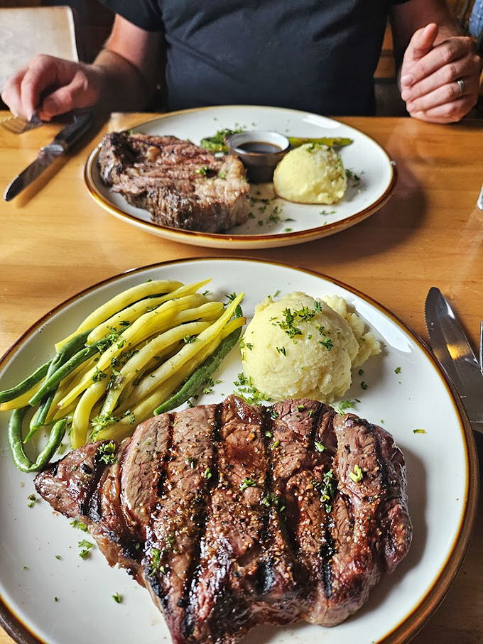 This isn't just dinner—it's edible artwork. Perfect grill marks on prime beef alongside vibrant vegetables and cloud-like mashed potatoes.