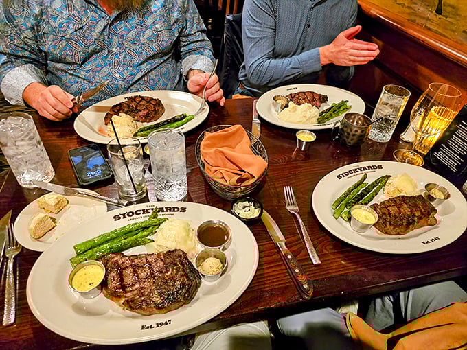 Steak night perfection: four plates of carnivorous bliss accompanied by asparagus that somehow doesn't feel like a compromise.