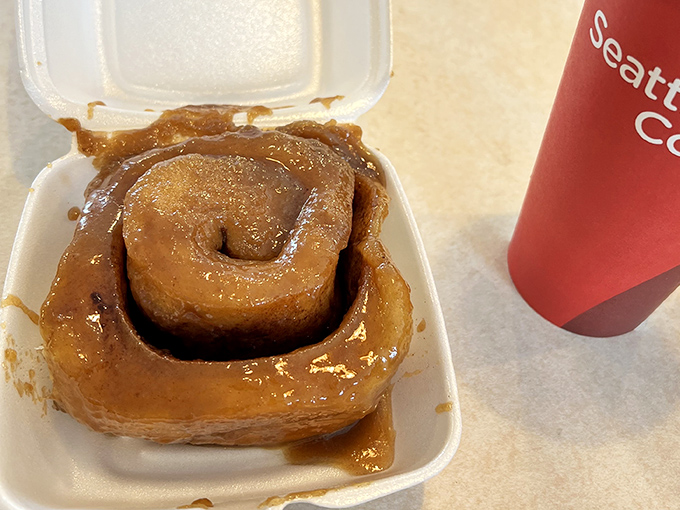 Behold the star attraction in its natural habitat—a sticky bun swimming in caramel glory. Napkins are not optional, they're survival gear.