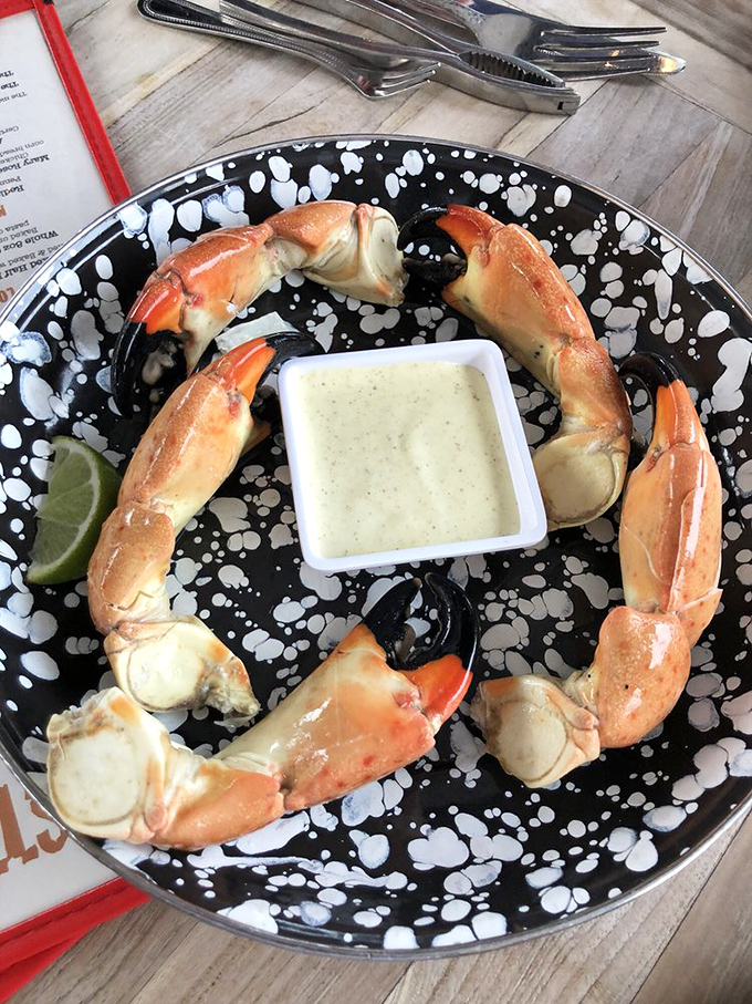 Stone crab claws arranged like a royal crown, with mustard sauce holding court in the center. Sweet meat that makes the cracking worth every effort.