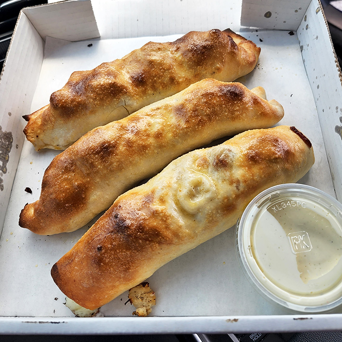 Behold the legendary stuffed breadsticks in their natural habitat. Golden-brown on the outside, molten cheese paradise on the inside.