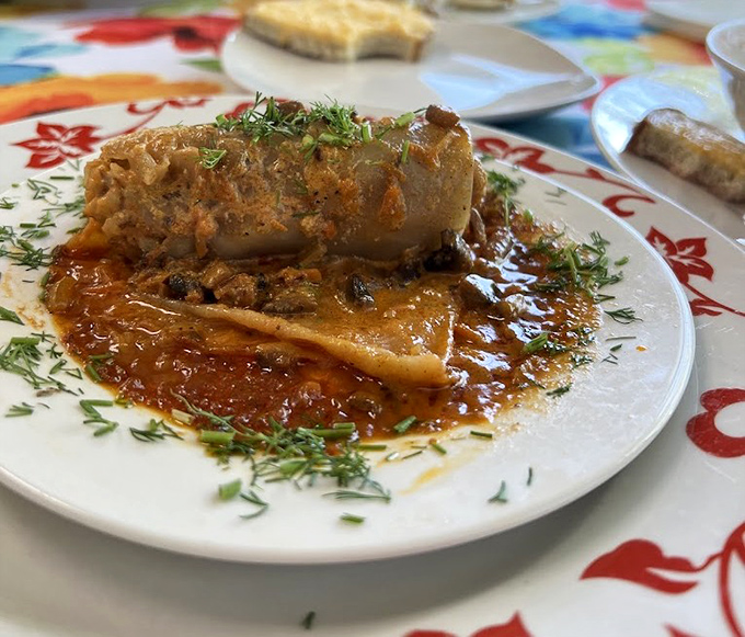 Behold the holupki in all its glory! This stuffed cabbage isn't just food &ndash; it's edible architecture with a sauce that demands to be sopped up.