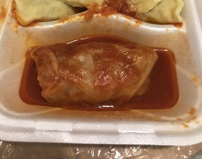 Behold the star attraction: stuffed cabbage bathing in tangy tomato sauce. This little package delivers more comfort than your favorite childhood blanket.
