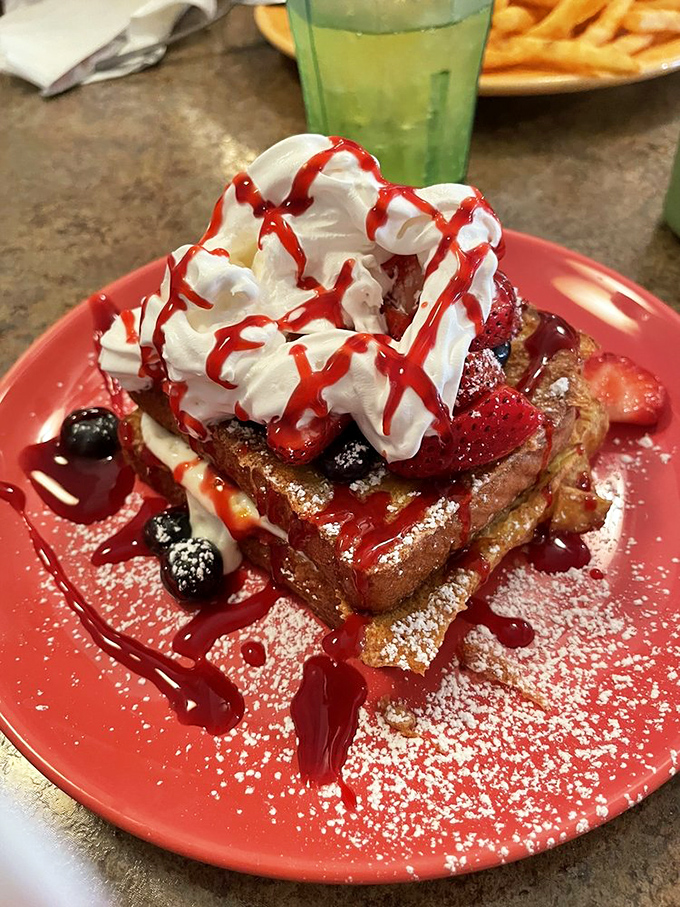 This isn't French toast—this is a strawberry-topped, whipped cream-crowned monument to everything breakfast should be.