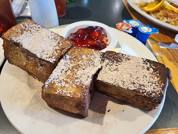 These thick slices of French toast aren't just breakfast&mdash;they're architecture. Powdered sugar dusted like fresh snow on a carb-lover's dream.