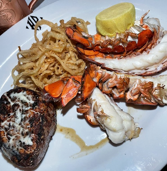 The surf and turf arrives like a celebrity power couple &ndash; the steak perfectly seared, the lobster tail ready for its butter bath, and those crispy onions stealing scenes.