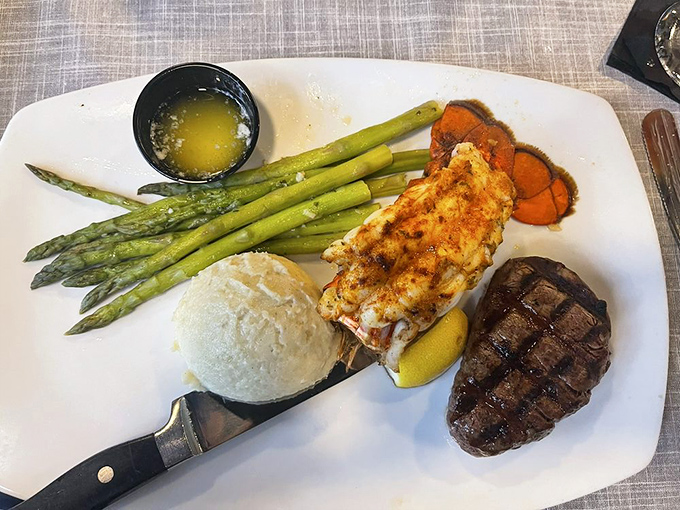 Surf and turf perfection: A tender steak alongside a buttery lobster tail with asparagus spears standing at attention—Neptune and the cattle ranchers called a truce.