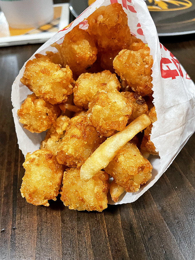 Golden-brown tater tots that crunch like your favorite vinyl record before melting into potato perfection. The side dish that frequently gets promoted to main event.