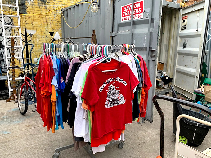 Vintage tees hanging against industrial shipping containers &ndash; the perfect Brooklyn juxtaposition of nostalgia and urban grit.