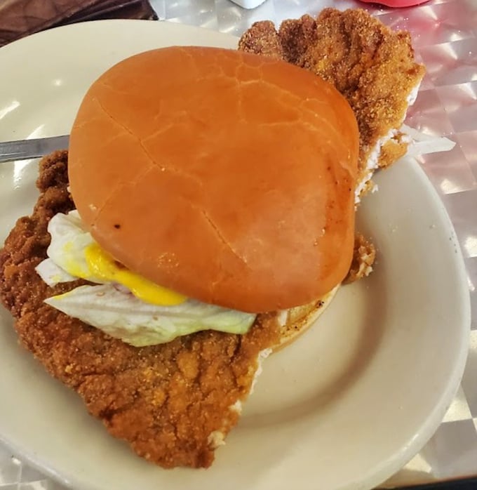 The legendary tenderloin sandwich in all its oversized glory. That golden-brown breading extending well beyond the bun is Indiana's version of food nirvana.