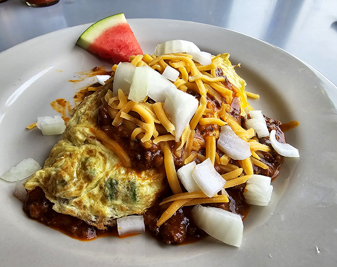 Behold the legendary Texas Omelet &ndash; a fluffy egg blanket wrapped around veggies, smothered in chili, and topped with enough cheese to make Wisconsin nervous.