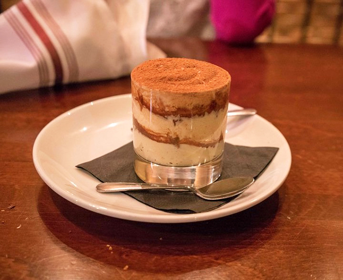 Behold, the tiramisu that launched a thousand return visits. Perfectly layered, dusted with cocoa, and served in a glass that showcases its architectural perfection.