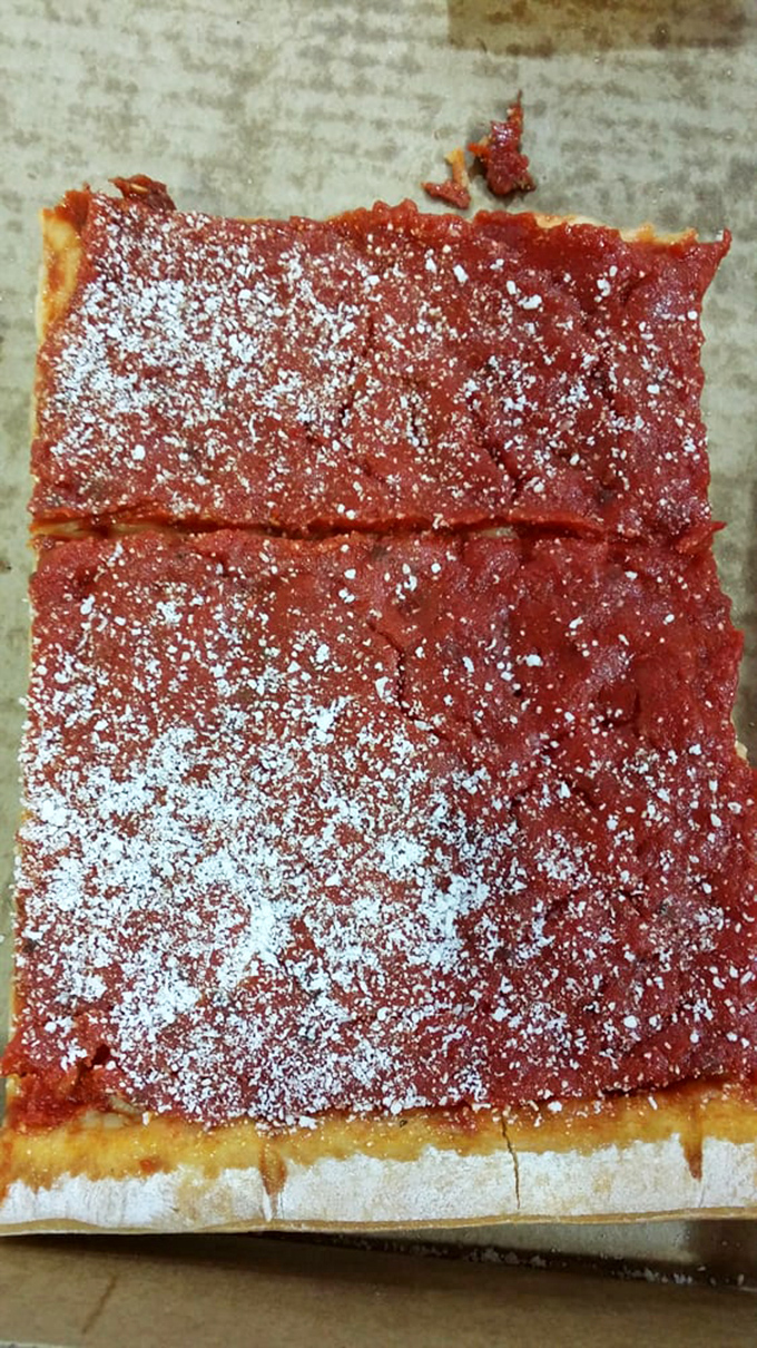 Behold the star attraction: Corropolese's legendary tomato pie, where that perfect sauce-to-crust ratio achieves culinary nirvana.