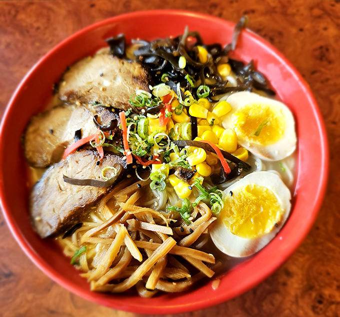 Behold the bowl that launched a thousand satisfied sighs &ndash; tonkotsu perfection in red.