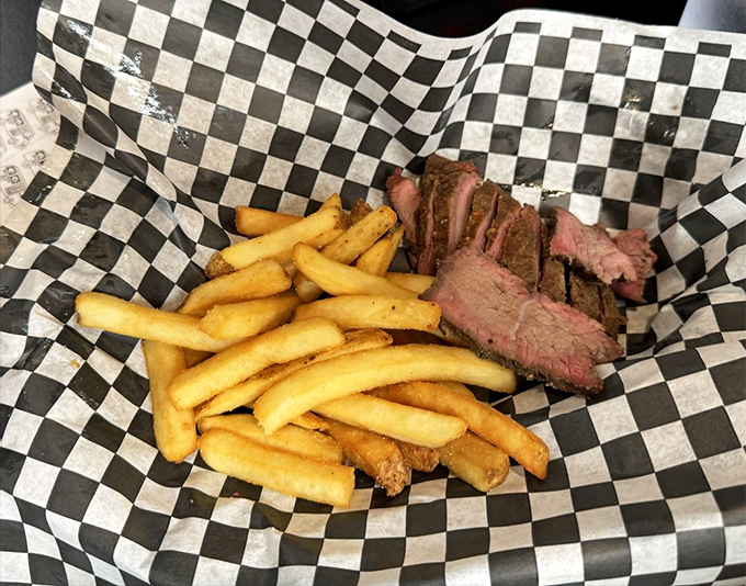 Perfectly pink tri-tip slices nestled against golden fries. The smoke ring on that meat is the barbecue equivalent of a Michelin star.