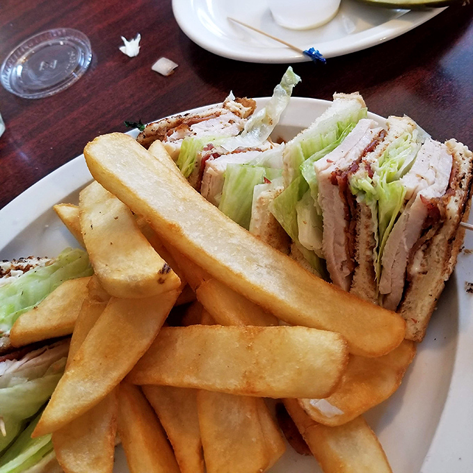 This turkey club isn't just stacked&mdash;it's architectural genius with layers of real roasted turkey, crisp bacon, and fresh veggies that make every bite a celebration.