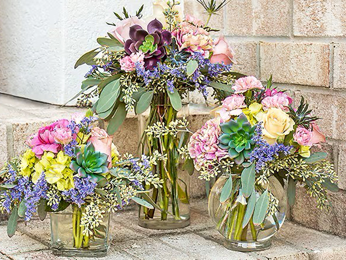 Who knew Dollar Tree vases could transform simple flowers into arrangements worthy of a high-end wedding? Martha Stewart, eat your heart out!