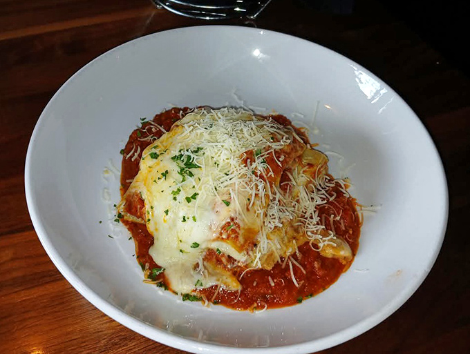 This isn't just food; it's edible artwork. The Veal Parmigiana arrives like a saucy masterpiece topped with a golden cheese canopy.