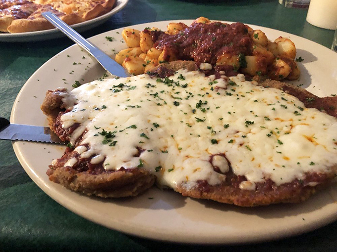 Behold the star of the show: veal parmesan that could make angels sing, with cheese melted to golden perfection and potatoes that refuse to play second fiddle.