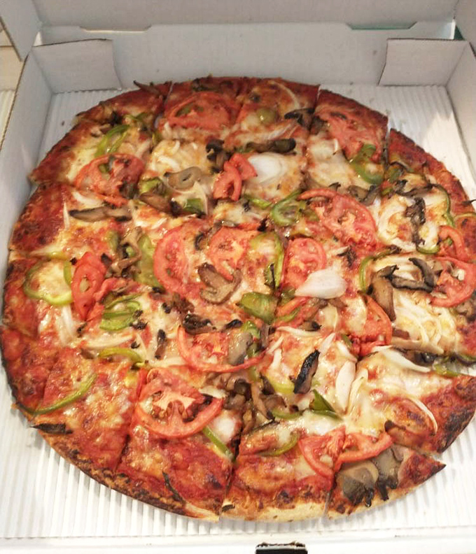 This veggie pizza isn't trying to win a beauty contest, but those fresh tomatoes, green peppers, and mushrooms are staging a delicious rebellion against boring health food.