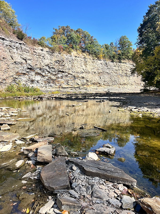Nature carved this limestone canvas over millennia. The Vermilion River's reflection doubles the beauty in this peaceful sanctuary.