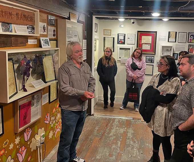 Visitors listen intently during a guided tour. Even the most macabre collections benefit from context, turning morbid curiosity into historical understanding.