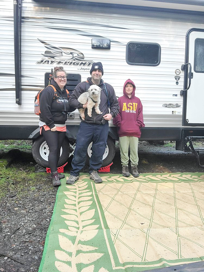 Happy campers with their four-legged adventure buddy. Even the dog looks impressed with their choice of vacation spot.