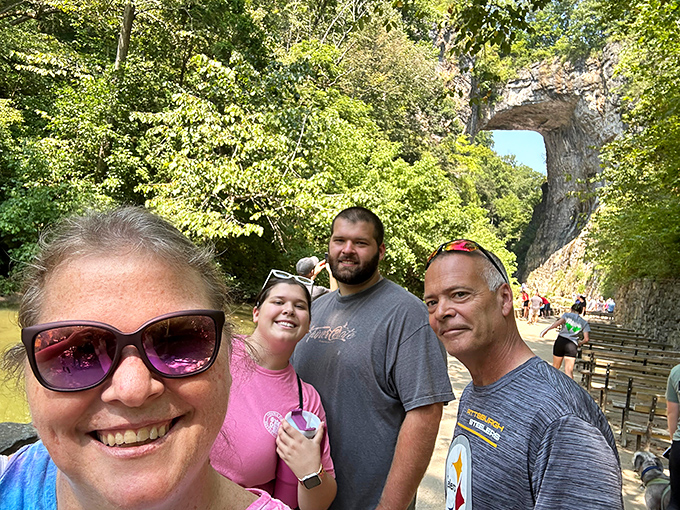Happy visitors capture the obligatory "we were here" shot beneath the massive arch&mdash;proof that some things are actually better than their Instagram versions.