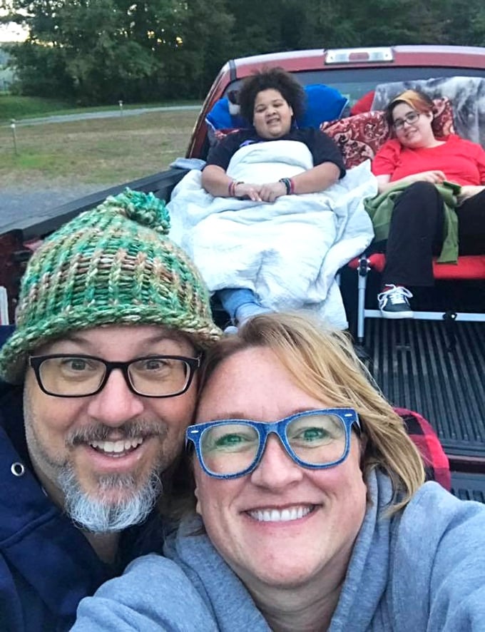 Family movie night elevated to an art form. The pickup truck bed transformed into the coziest living room under West Virginia's starlit ceiling.