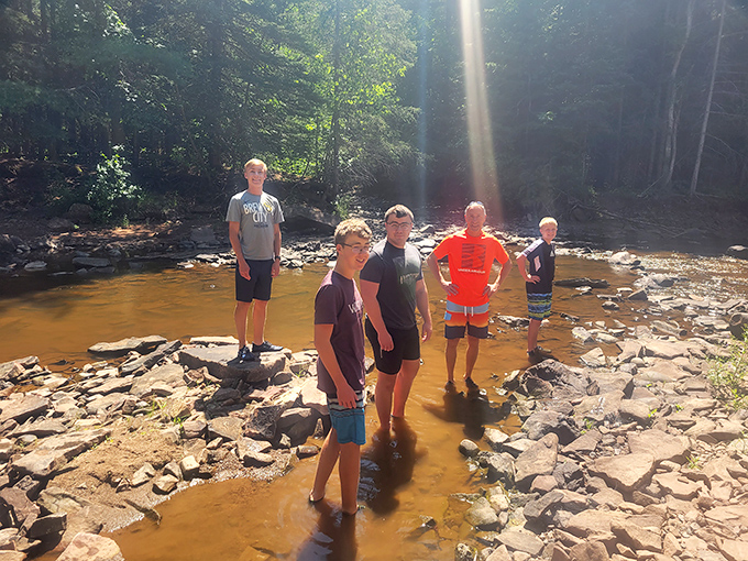 Summer's perfect playground where cool river waters offer sweet relief from hiking trails. Just watch that first step—it's a doozy!
