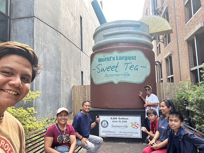 Visitors gather to document their pilgrimage to the sweet tea shrine. Nothing brings people together like comically oversized beverages. 