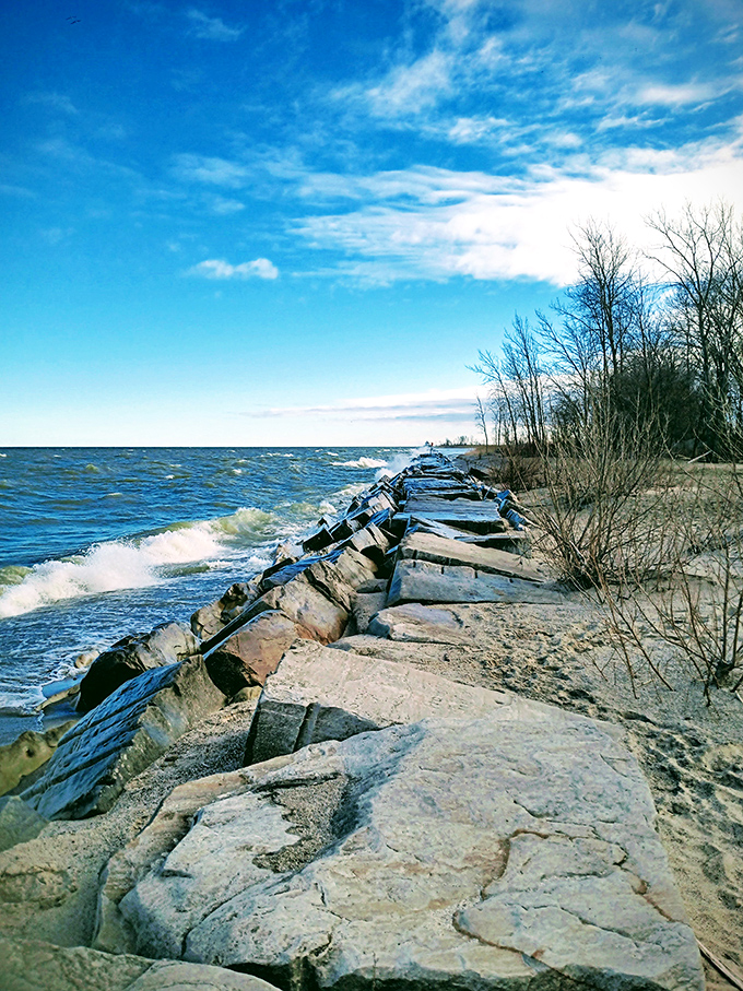 Lake Erie's shoreline offers a rocky path to contemplation, where waves crash against stone breakwaters in nature's most reliable therapy session.