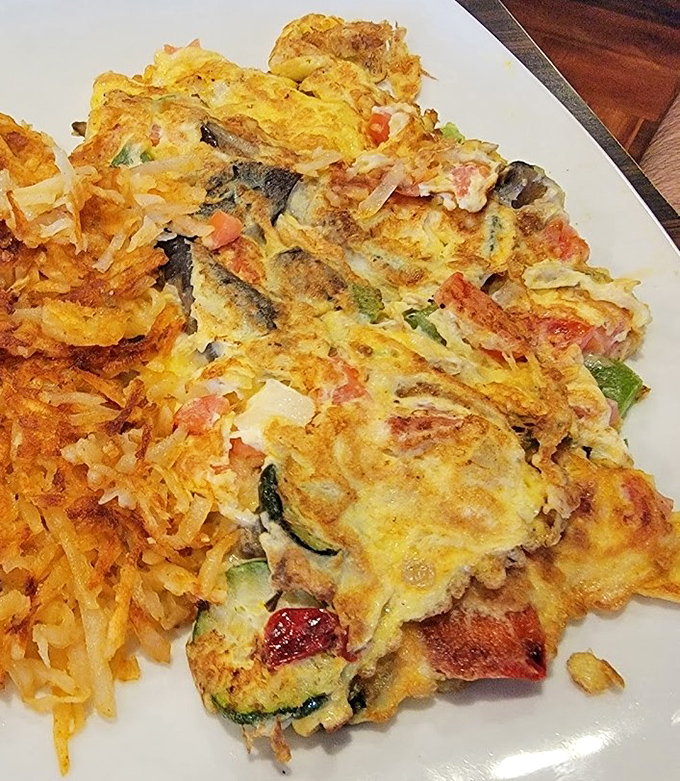 Behold the Western Omelet in its natural habitat&mdash;a perfect marriage of fluffy eggs, diced ham, and colorful peppers with a side of golden hash browns.