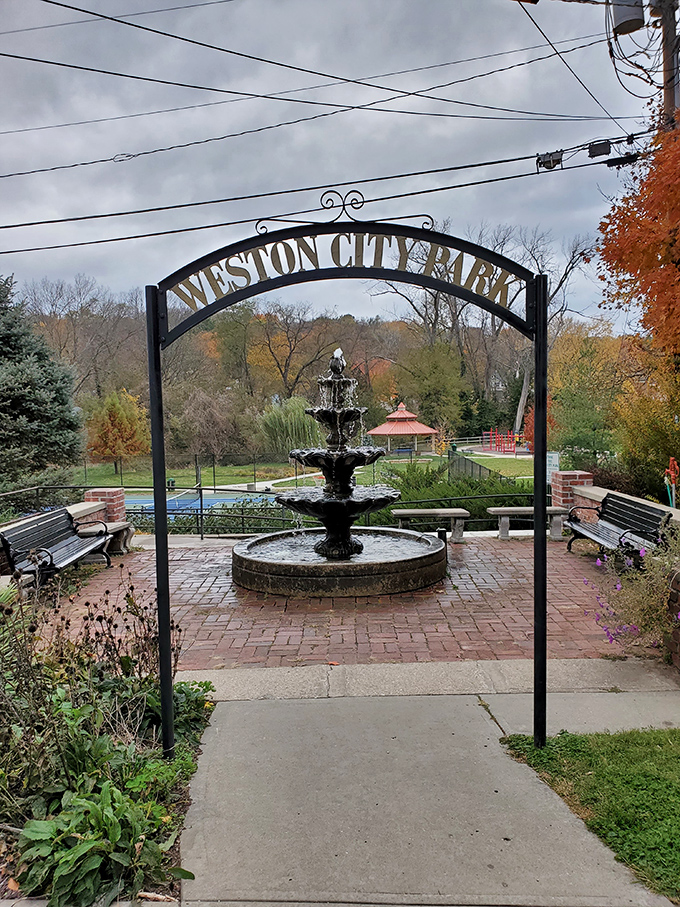 Weston City Park's fountain creates a peaceful oasis where you can sit, contemplate life, and wonder why more places don't have charming iron archways.