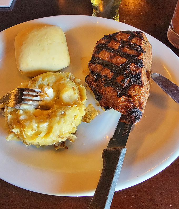 The star of the show: a perfectly grilled whiskey steak with sides that aren't afterthoughts. That grill mark pattern deserves its own Instagram account.