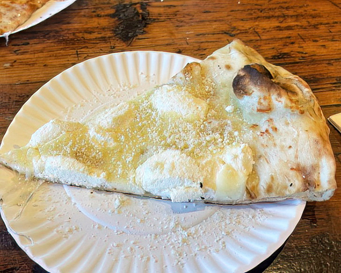 The white pizza &ndash; a canvas of creamy indulgence that proves sometimes the absence of red sauce creates a masterpiece all its own.