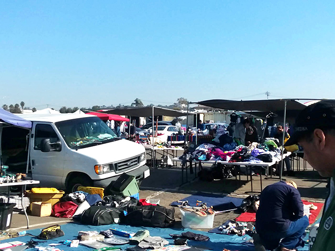 Colorful canopies create a patchwork marketplace where children's clothing and accessories await families looking to stretch their dollars further.