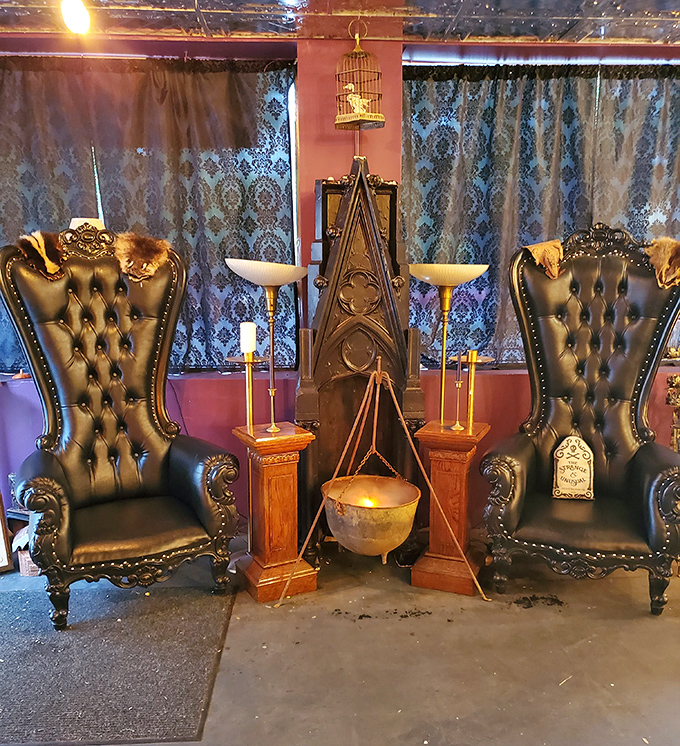Gothic grandeur meets witchy wonder in this seating area where high-backed thrones and ceremonial cauldrons create the perfect spooky selfie spot.