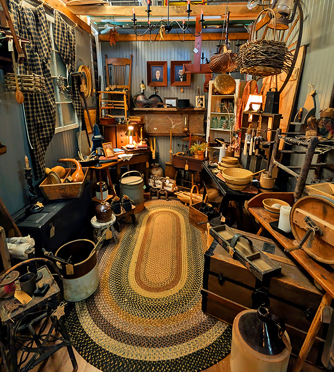 A perfectly curated chaos of Americana that would make any collector weak in the knees. That braided rug anchors a room where every object tells a story.