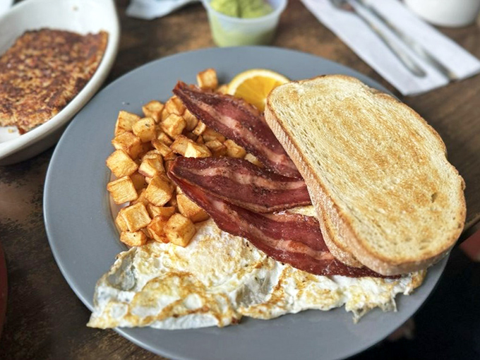 Breakfast perfection doesn't need to be complicated. Golden toast, perfectly cooked eggs, crispy home fries, and bacon that should win awards.