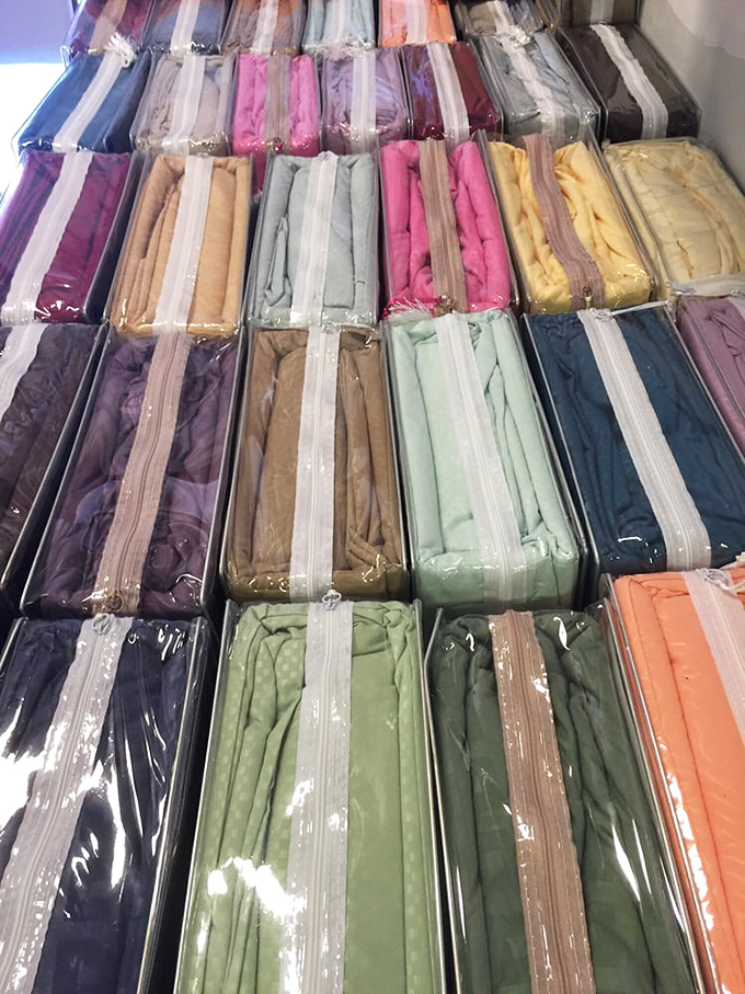 Bedsheets in every color of the Florida sunset, neatly packaged and waiting to transform guest rooms across the Sunshine State.